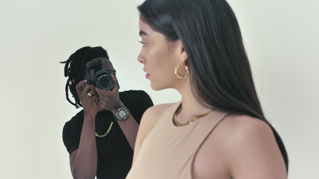 Photographer portraying a woman from different angles - Free Stock Video