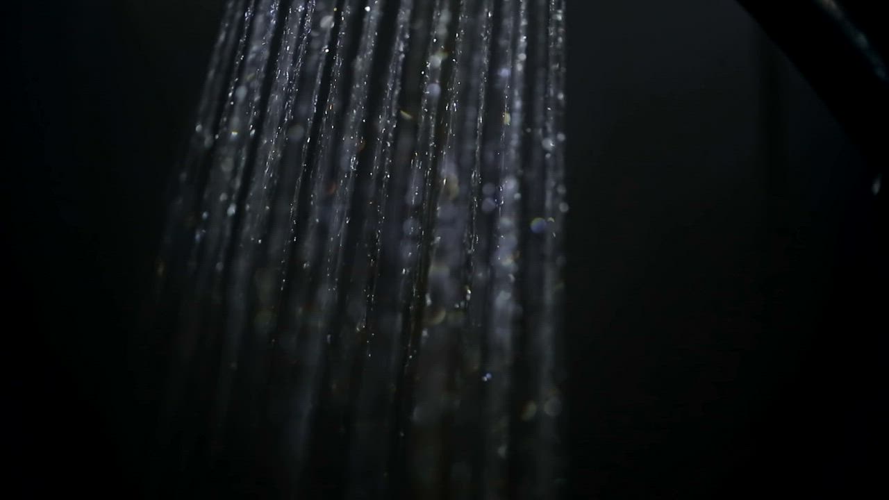 Stream of shower water on black background - Free Stock Video