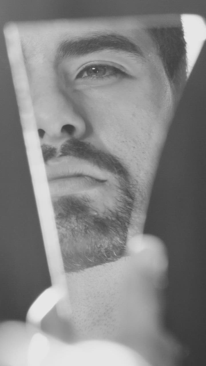 Reflection of a man in a piece of broken mirror - Free Stock Video