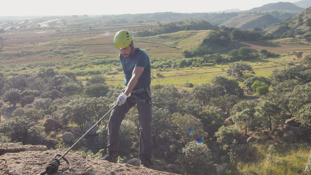 Man slowly coming down from the top of a hill - Free Stock Video