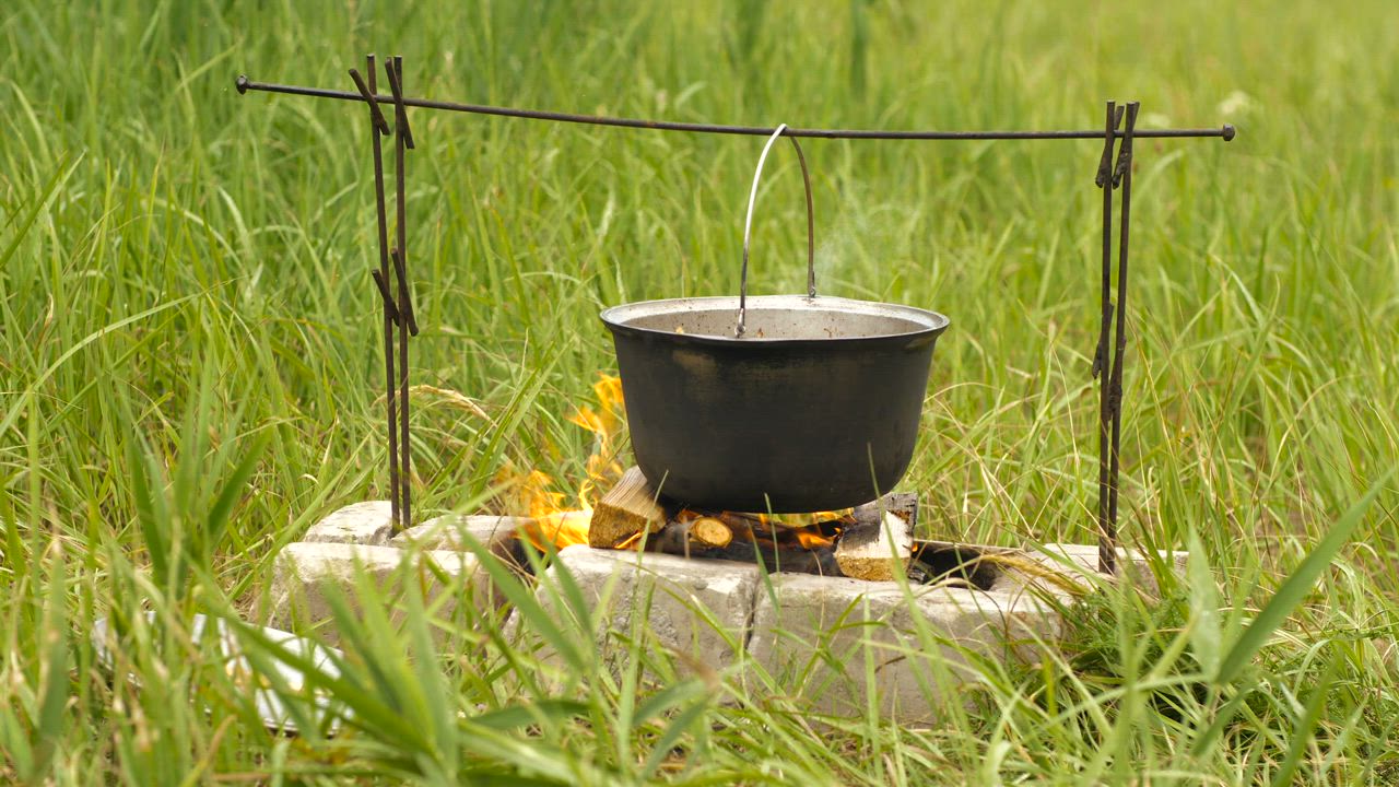 Cooking soup in a country cauldron - Free Stock Video
