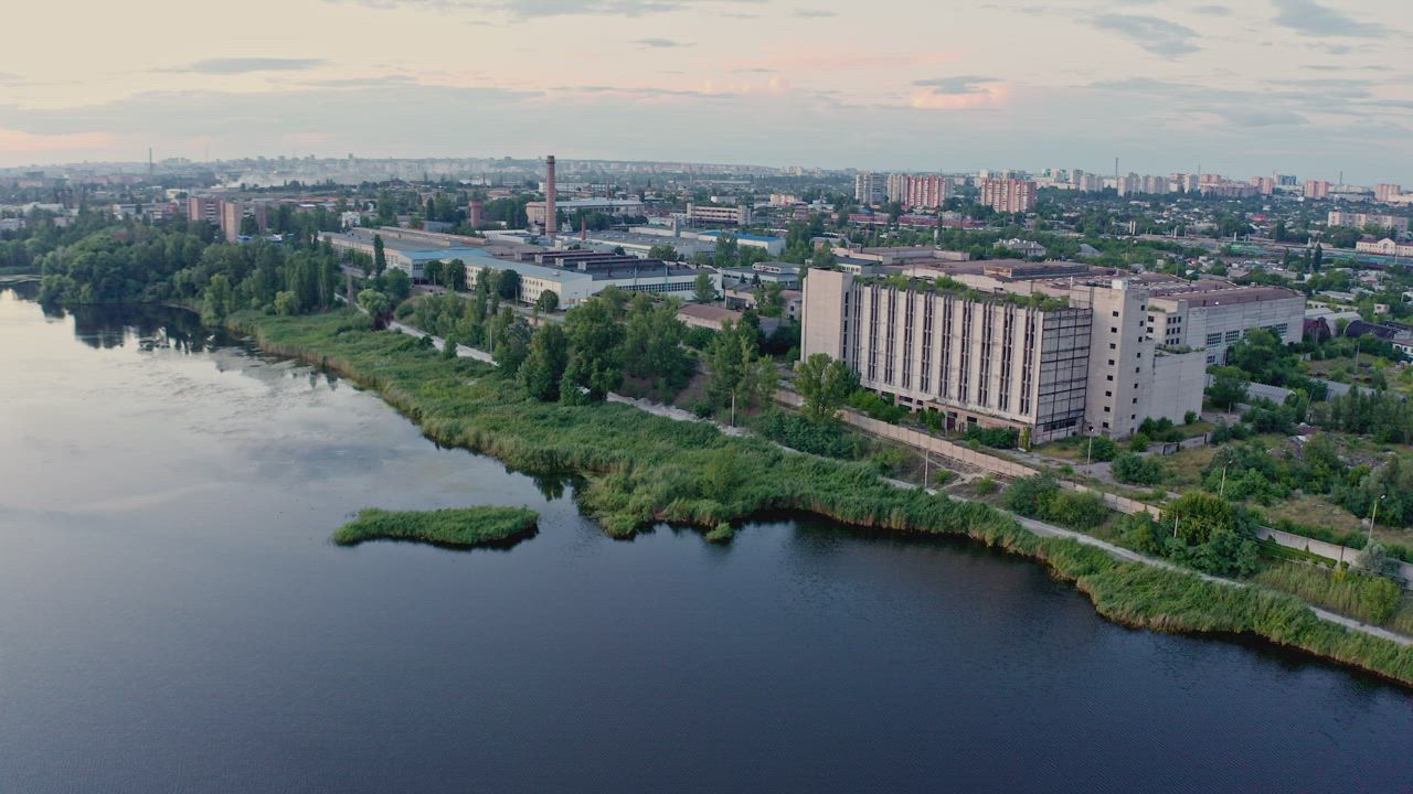 Production factories by the shore of a lake - Free Stock Video