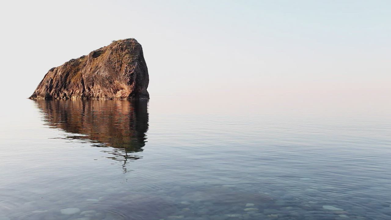 Boulder on shore in the sea, landscape - Free Stock Video