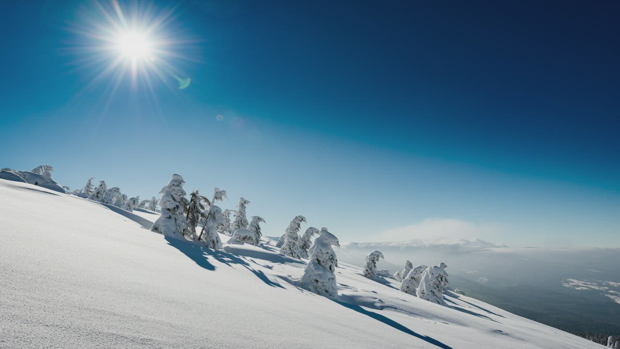 Snowy mountain under sunny sky - Free Stock Video
