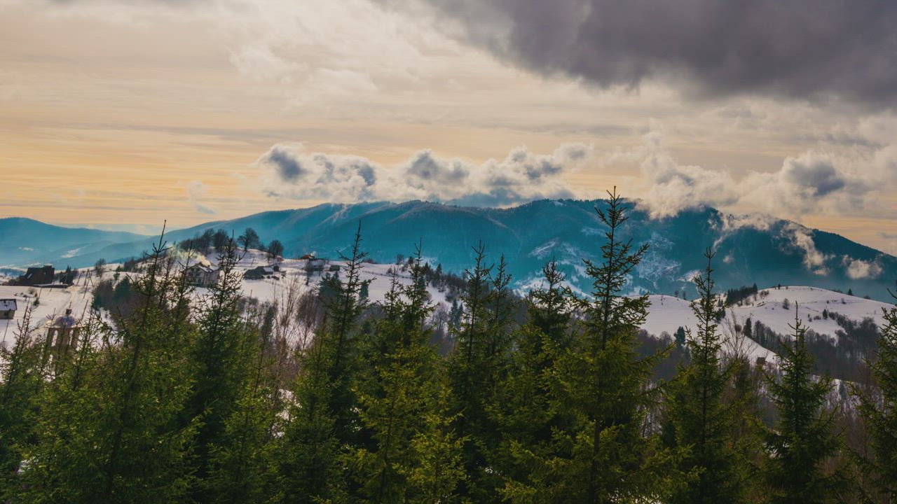 Clouds moving over cold forests - Free Stock Video