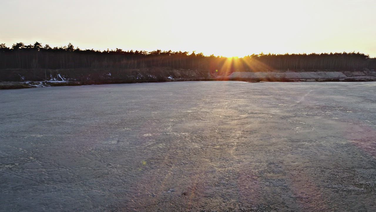 Big frozen lake near a forest - Free Stock Video