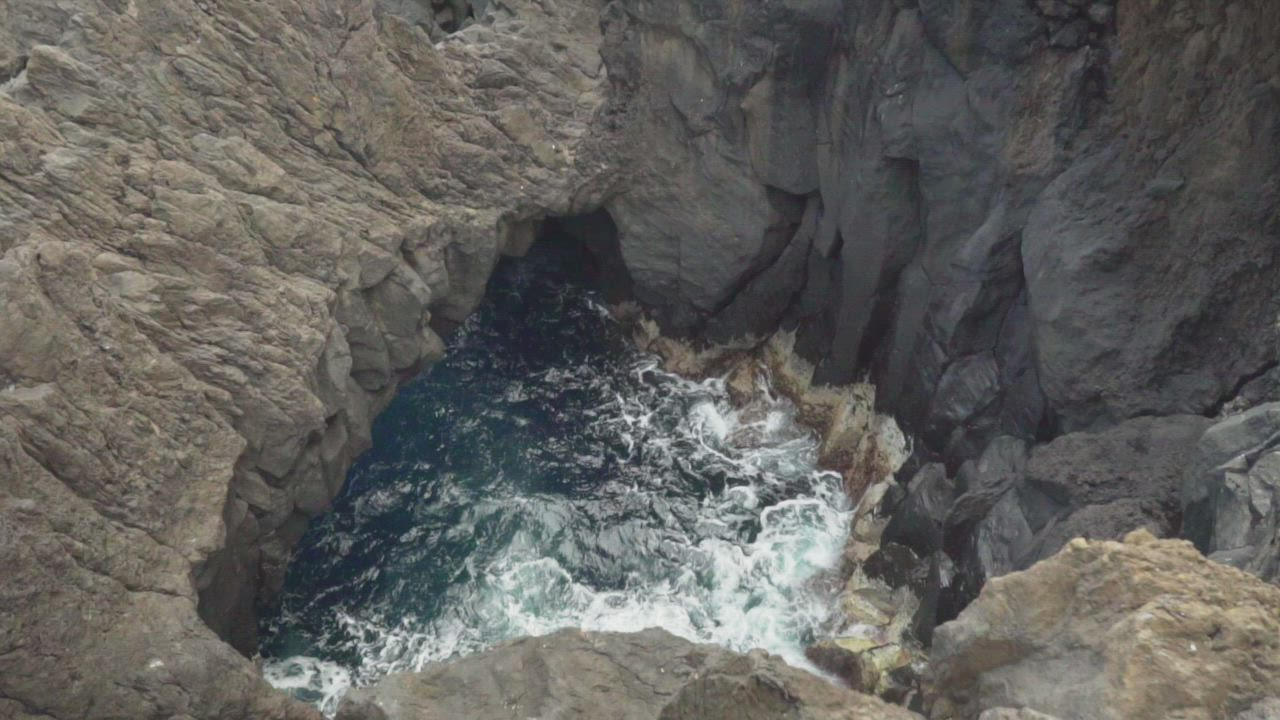 Sea cliff and waves - Free Stock Video