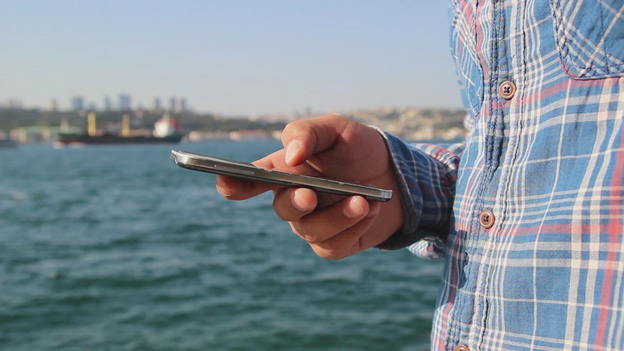Close up to a person using his smartphone - Free Stock Video