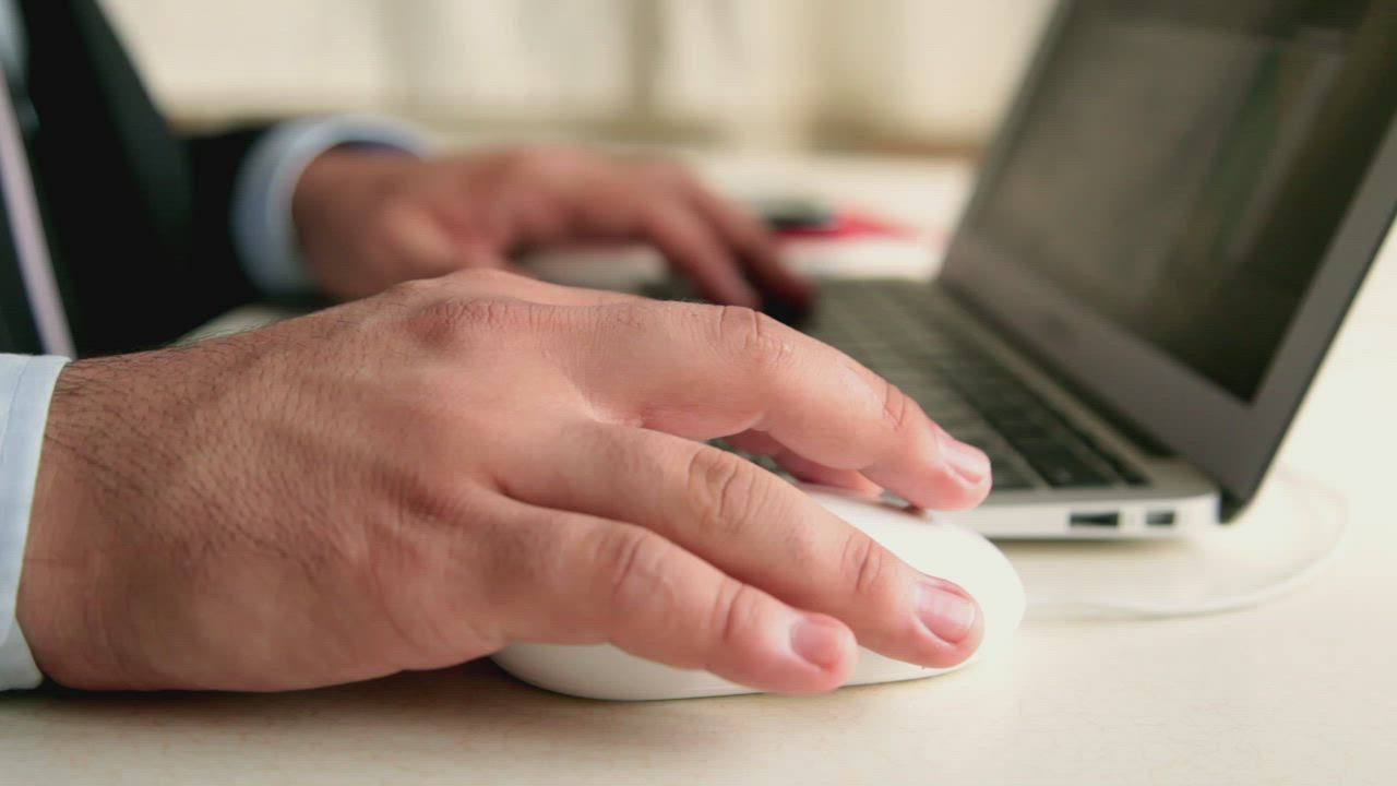 Businessman in suit working on a Macbook - Free Stock Video
