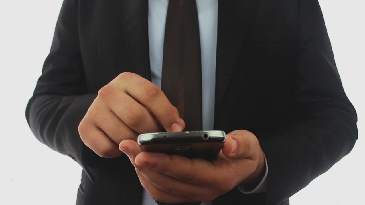 Businessman texting with a smartphone - Free Stock Video