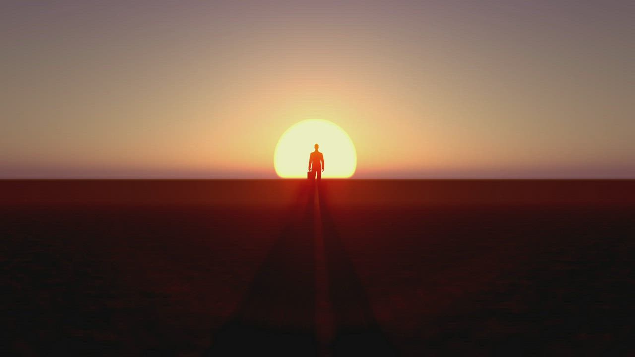 Businessman standing in front of the sunset - Free Stock Video