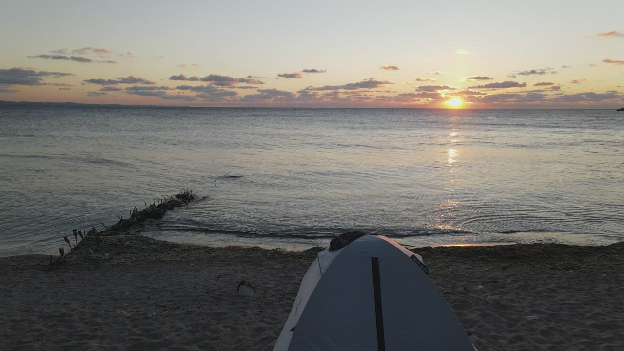 Moving through the air on a beach during sunset - Free Stock Video