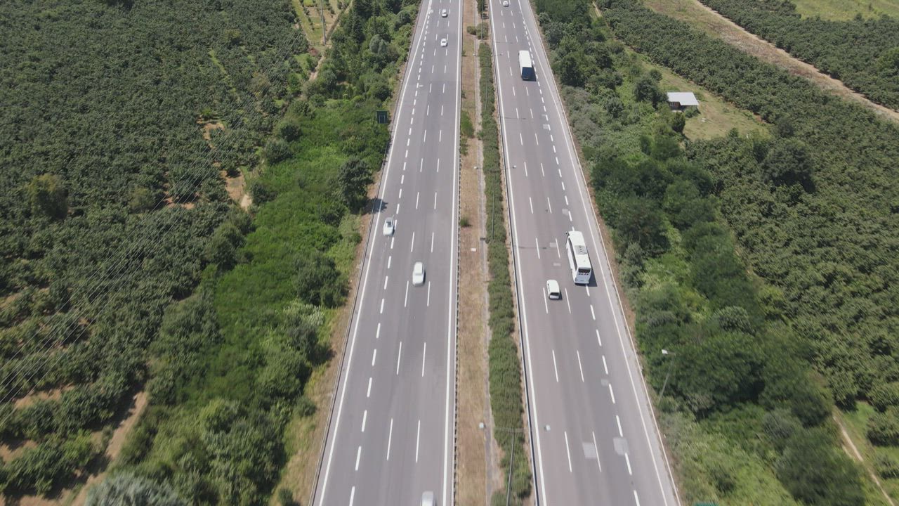 Highway with cars surrounded by vegetation - Free Stock Video