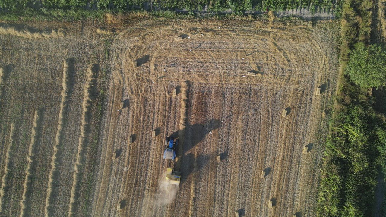 Tractor working in a field seen from above - Free Stock Video