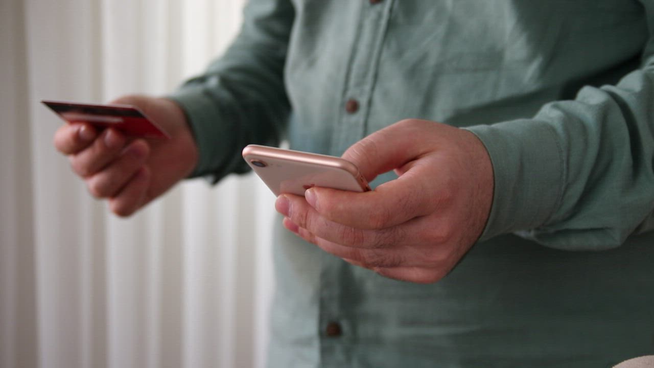 Entering bank data on a Smartphone - Free Stock Video