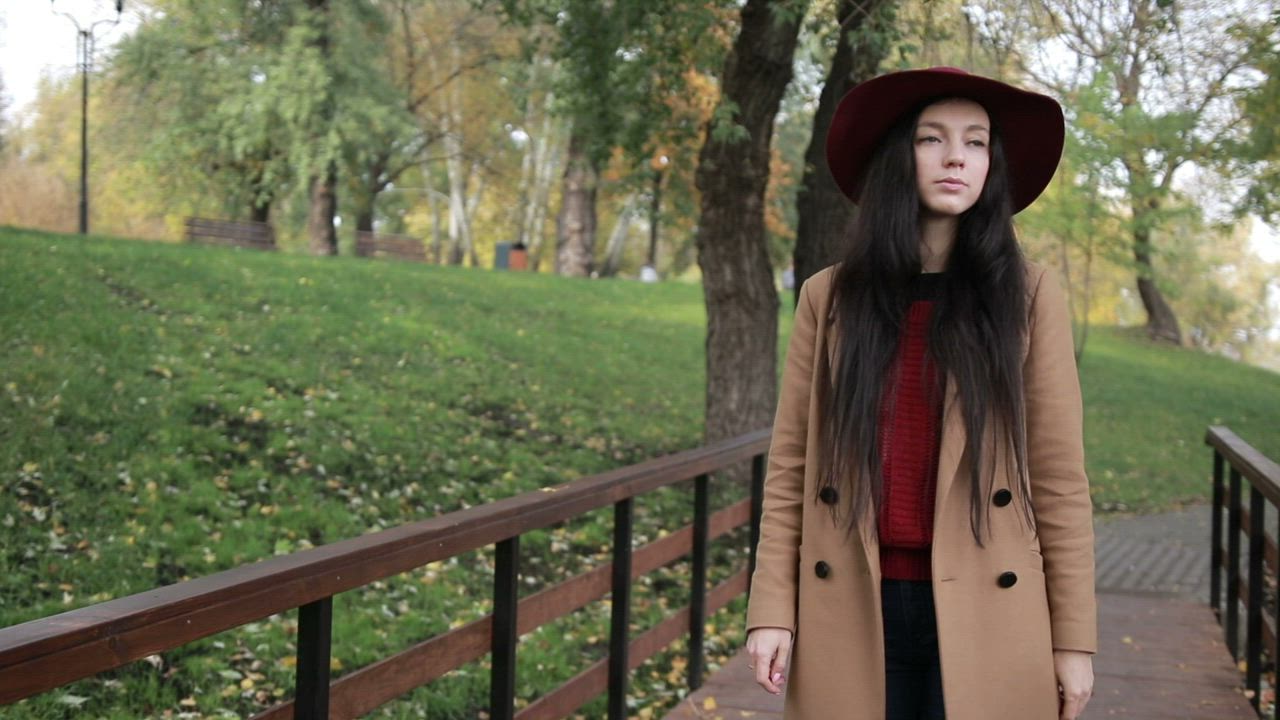 Woman walking alone through park in autumn - Free Stock Video