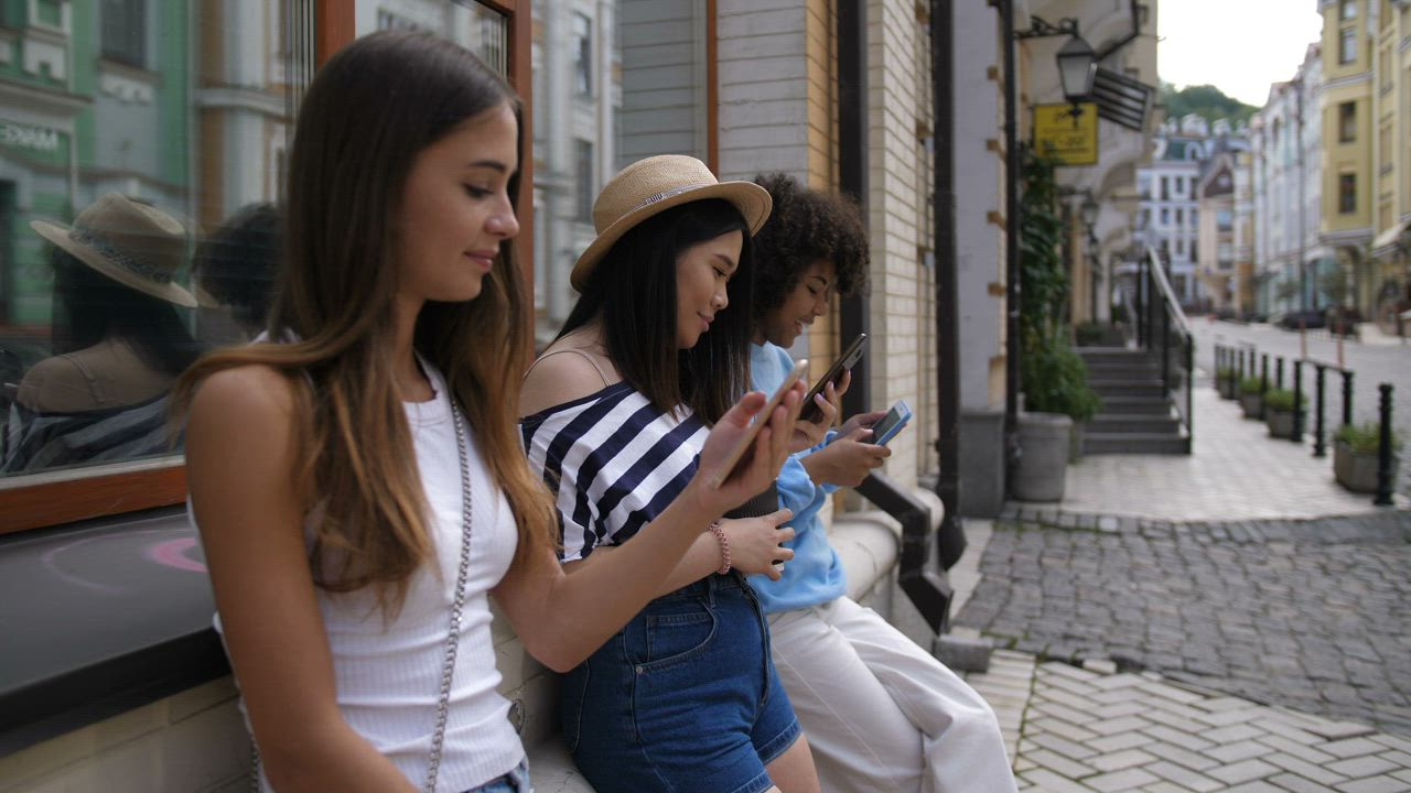 Friends on the street while using cell phones - Free Stock Video