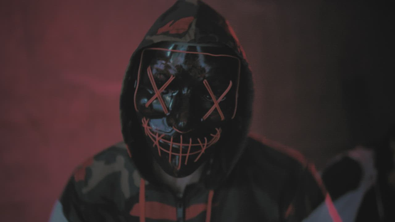 Popping dancer wearing a mask with neon lights - Free Stock Video