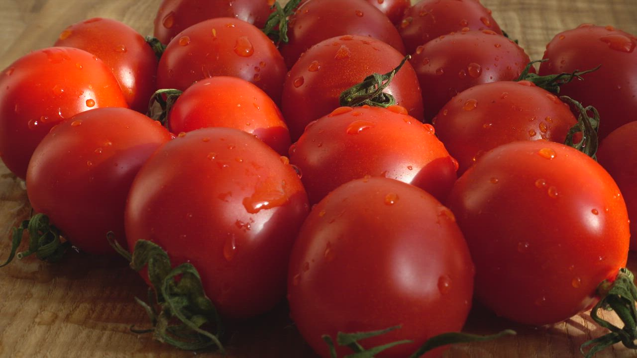 Set of wet tomatoes spinning in a close up shot - Free Stock Video