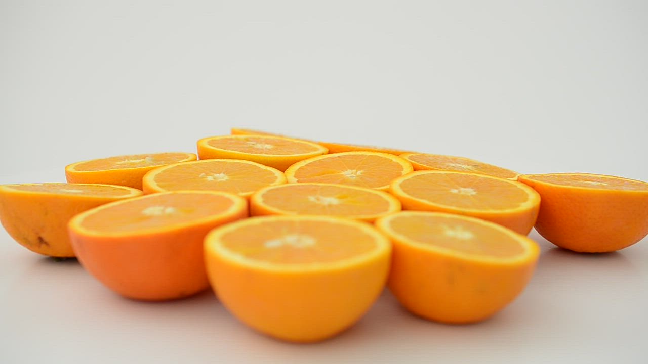 Split oranges rotating on a white background - Free Stock Video