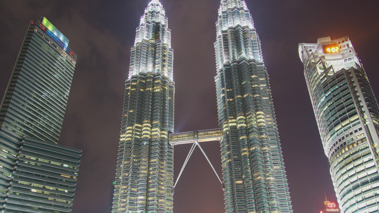 Large buildings lit up at night - Free Stock Video