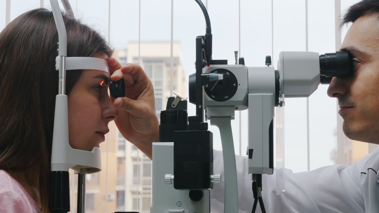 Eye exam with an ophthalmologist and a patient - Free Stock Video