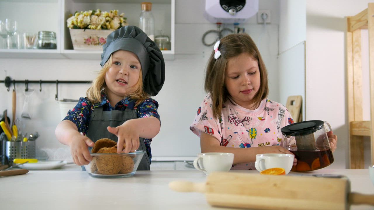Two girls after successfully baking cookies - Free Stock Video
