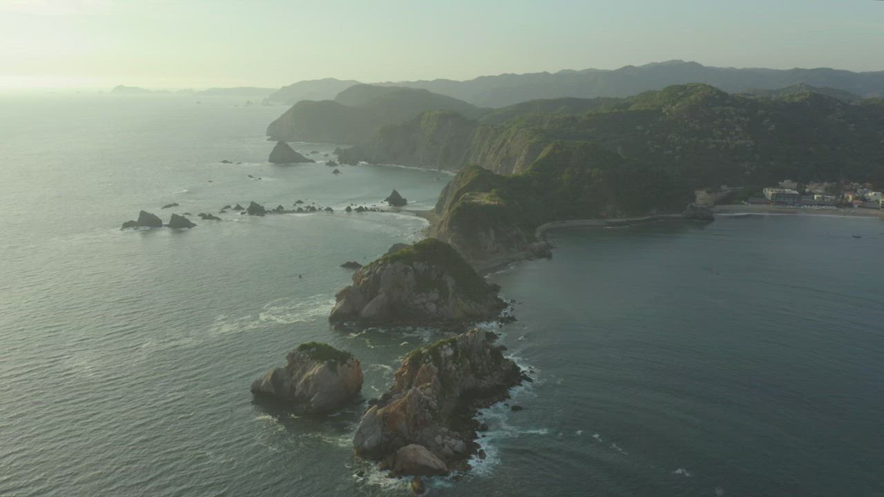 Relief on a coastline at sunset from above - Free Stock Video