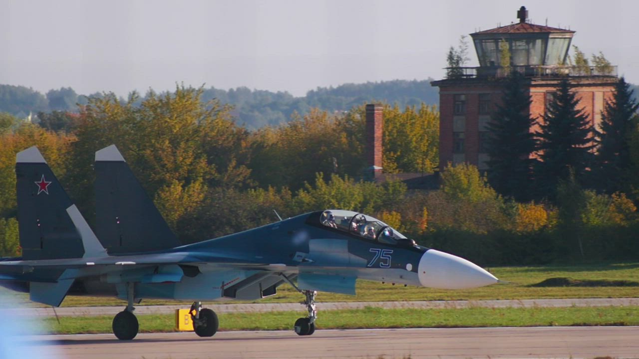 Jet moving down a runway in the distance - Free Stock Video