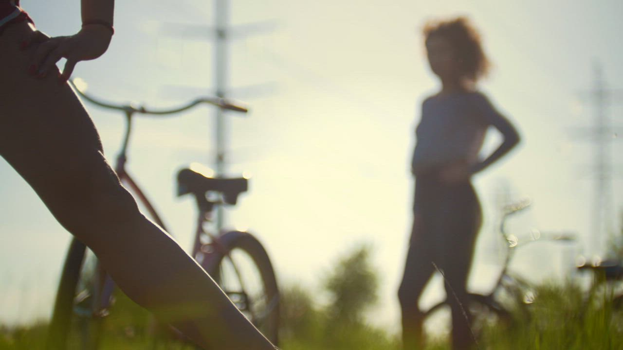 Two girls stretching during a bike ride - Free Stock Video