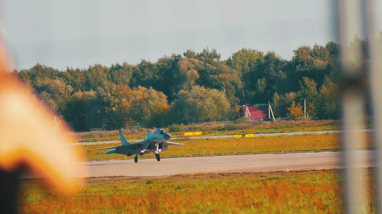 Jet moving in the distance down a runway - Free Stock Video