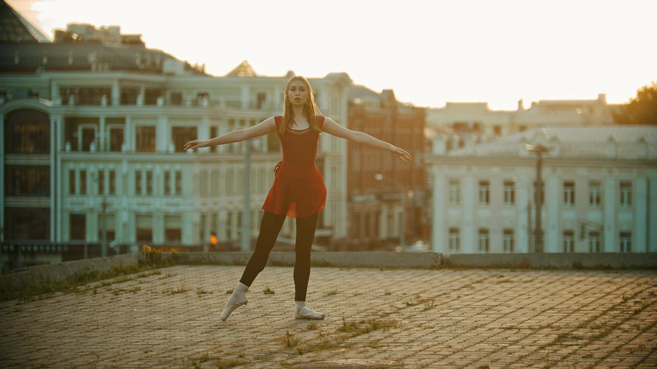 Girl dancing ballet on top of a building - Free Stock Video