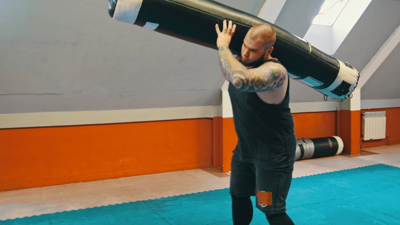 Big man doing heavy exercise in a gym - Free Stock Video
