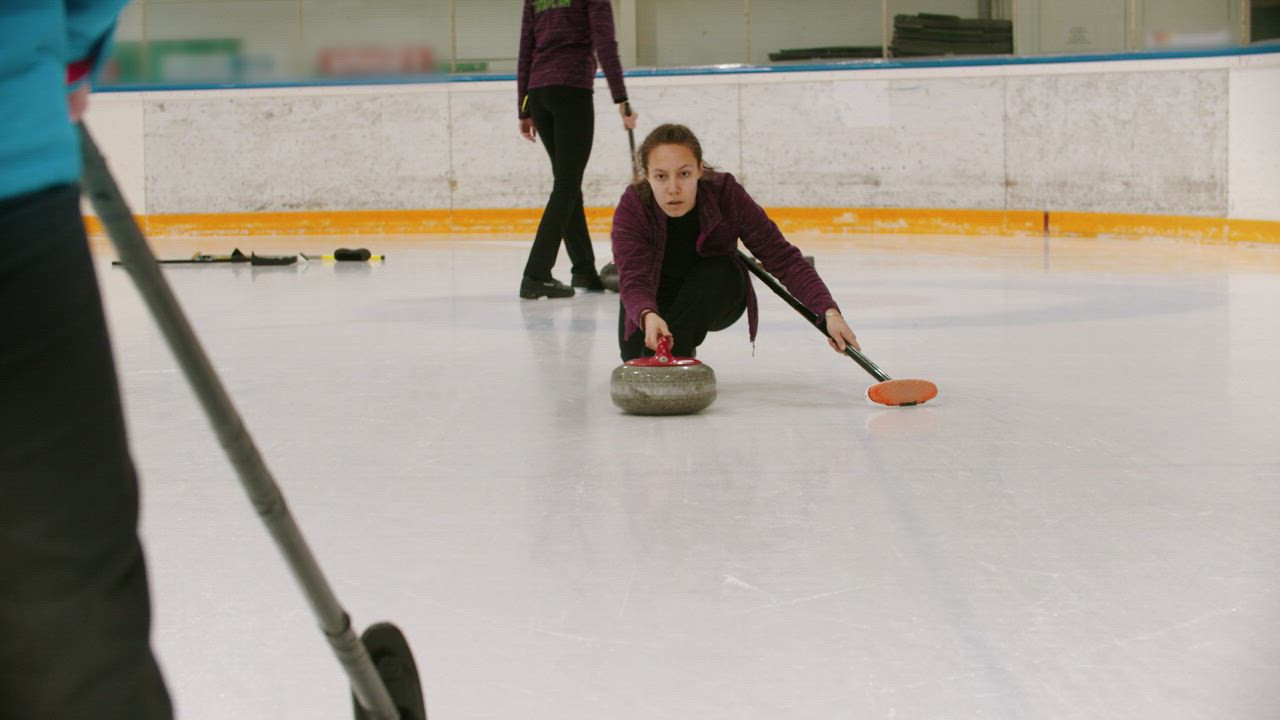 Woman curling player sliding on ice - Free Stock Video