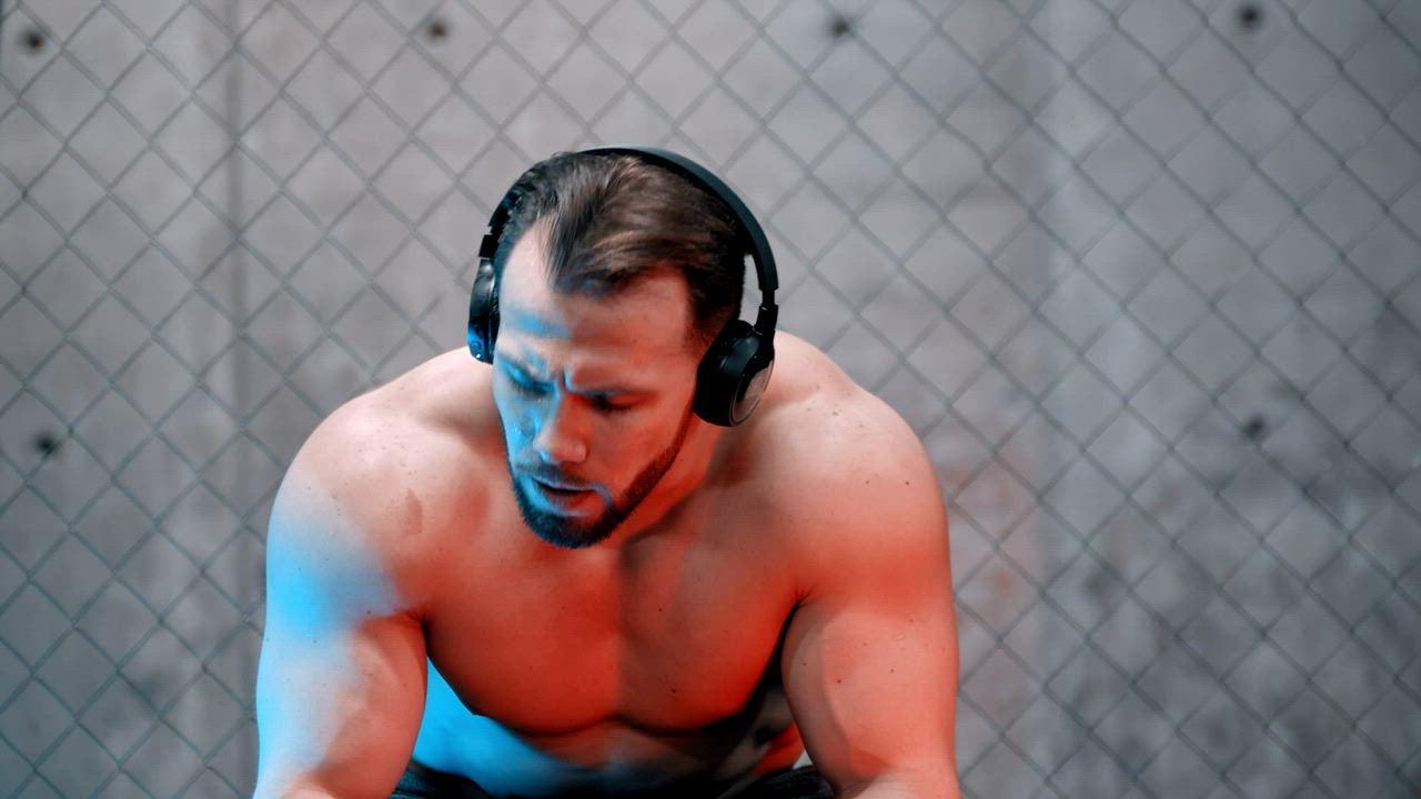 Male boxer resting sitting on a bench at the gym - Free Stock Video