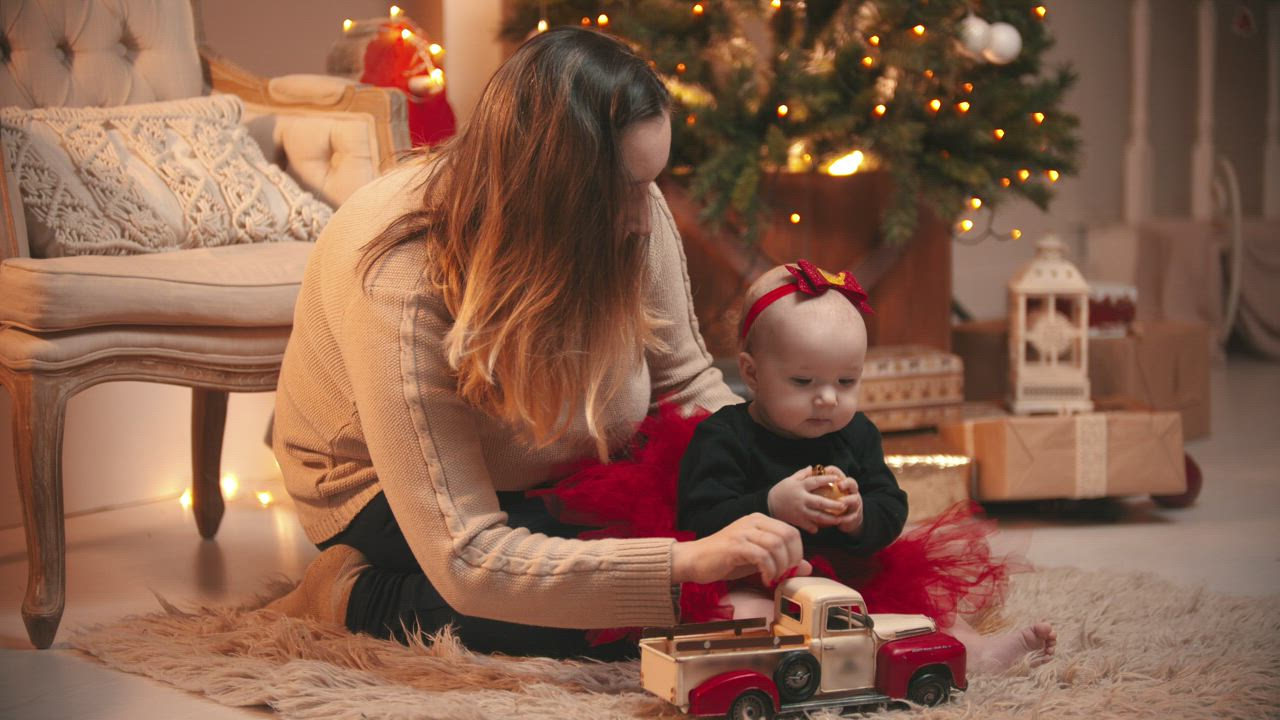 Happy mom with her baby on Christmas night - Free Stock Video