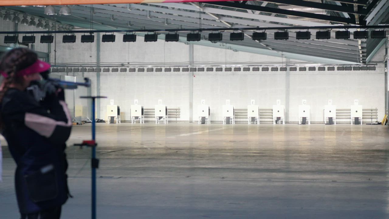 Girl practicing target shooting with a gun - Free Stock Video