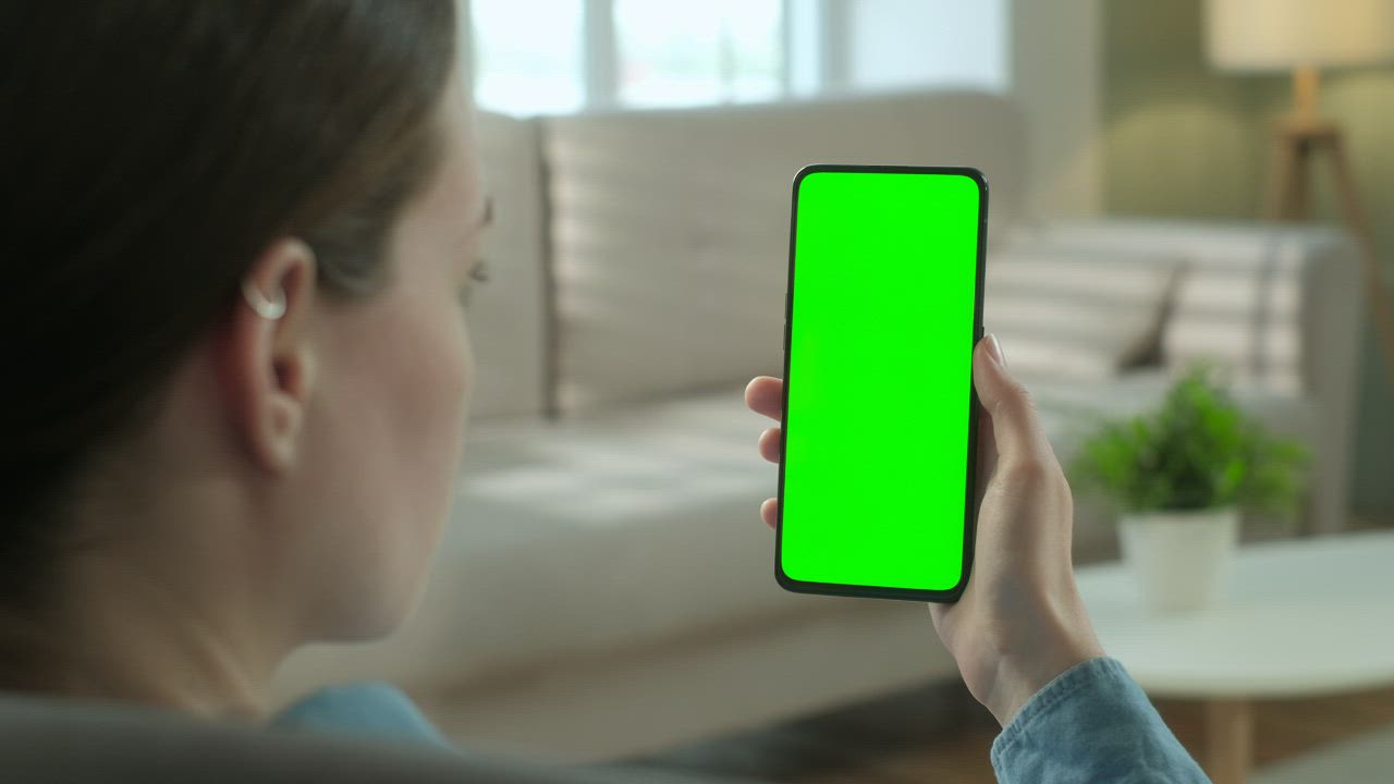 Woman watching to a green screen smartphone - Free Stock Video
