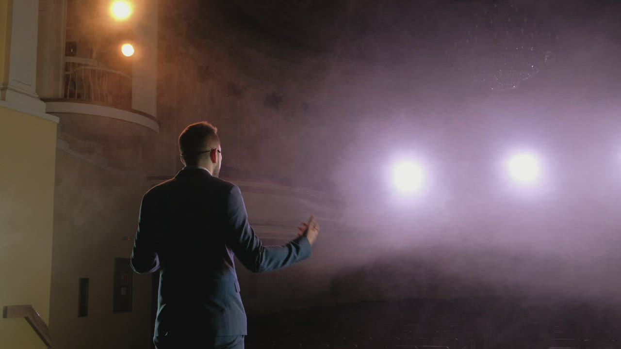 Successful speaker practicing on an empty stage - Free Stock Video