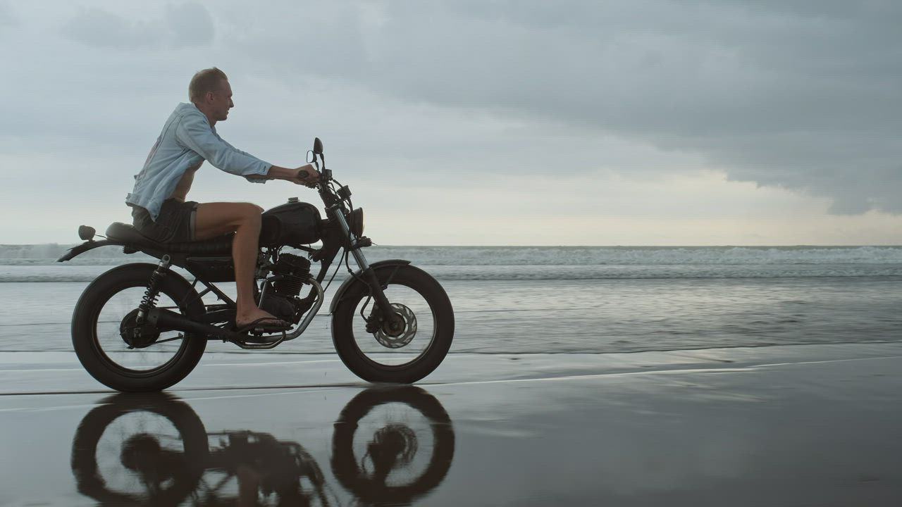 Biker riding on the beach - Free Stock Video