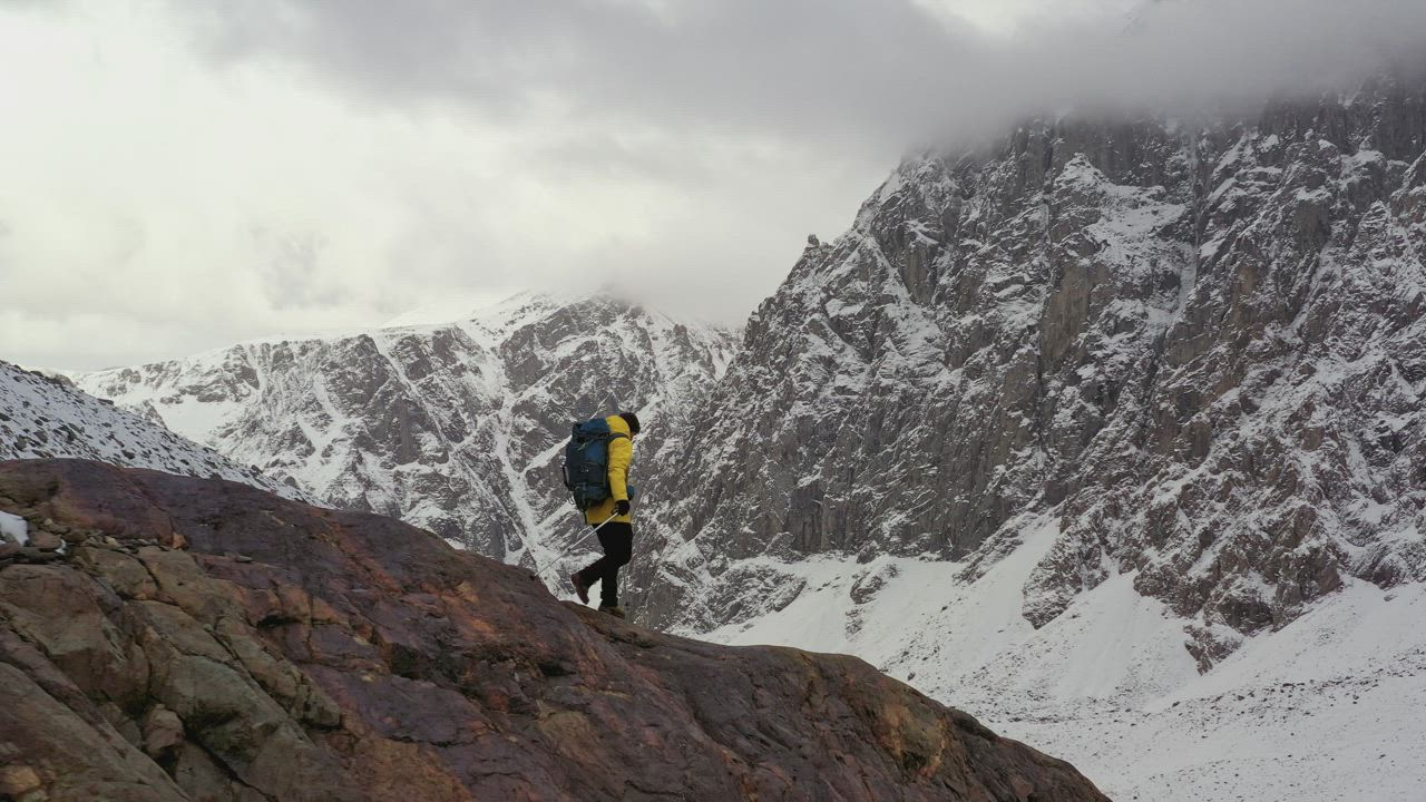 Mountaineer walking on a cliff in a winter mountain range - Free Stock ...