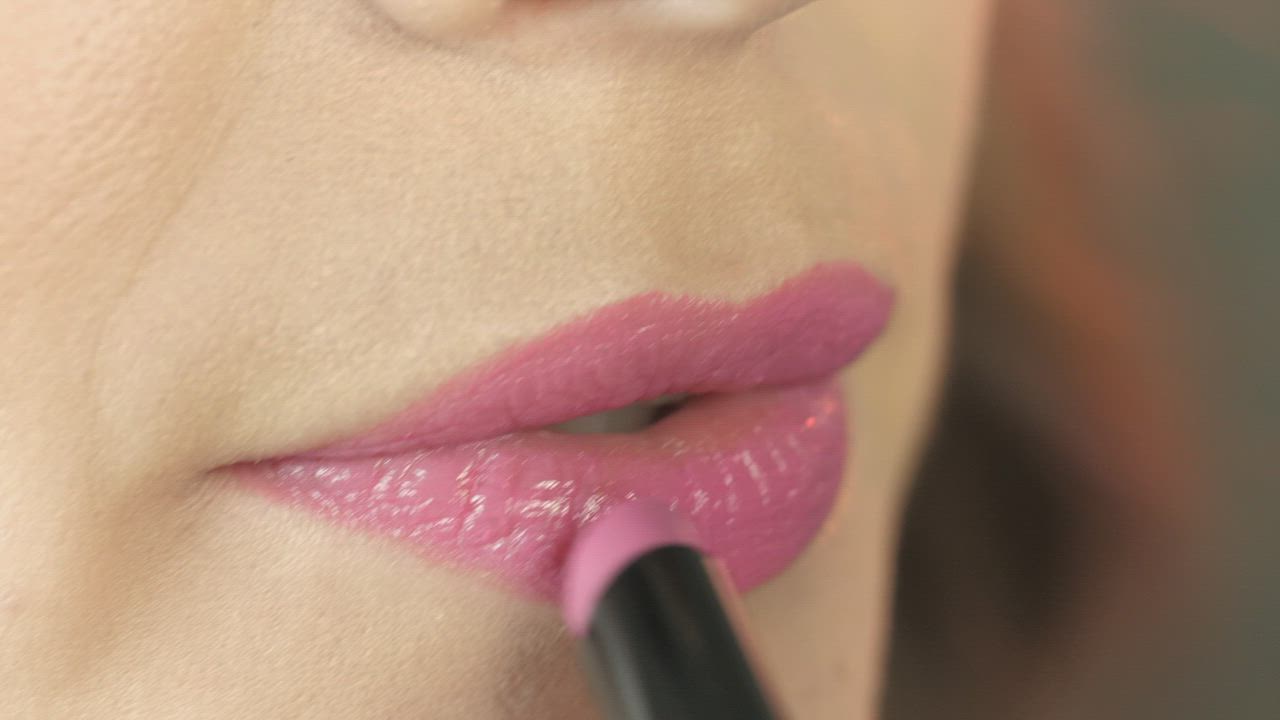 Woman applying pink lipstick - Free Stock Video