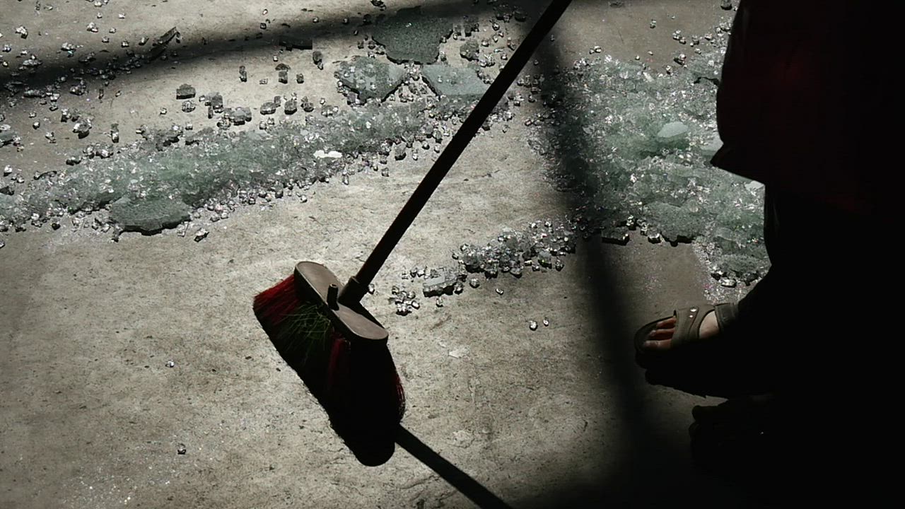 Person sweeping many broken glass from the floor - Free Stock Video