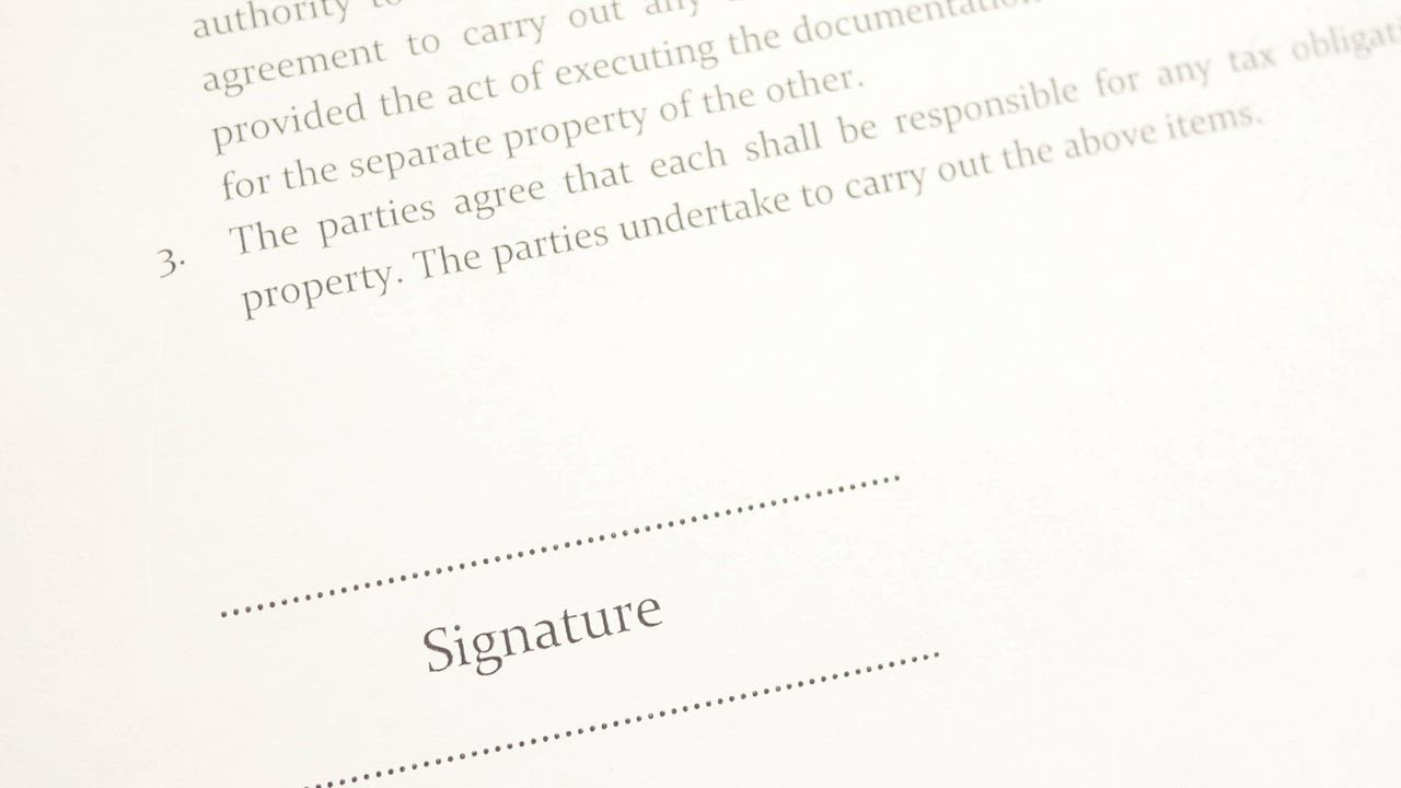 Signing a document with blue ink - Free Stock Video