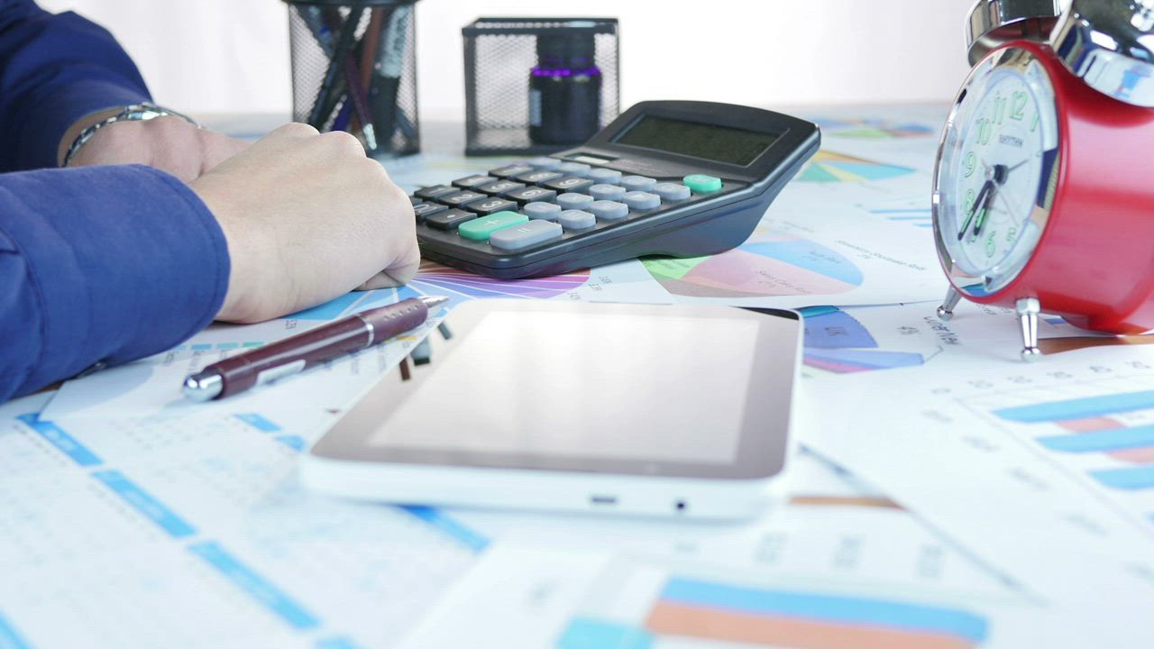 Person corroborating data from some graphs on paper - Free Stock Video