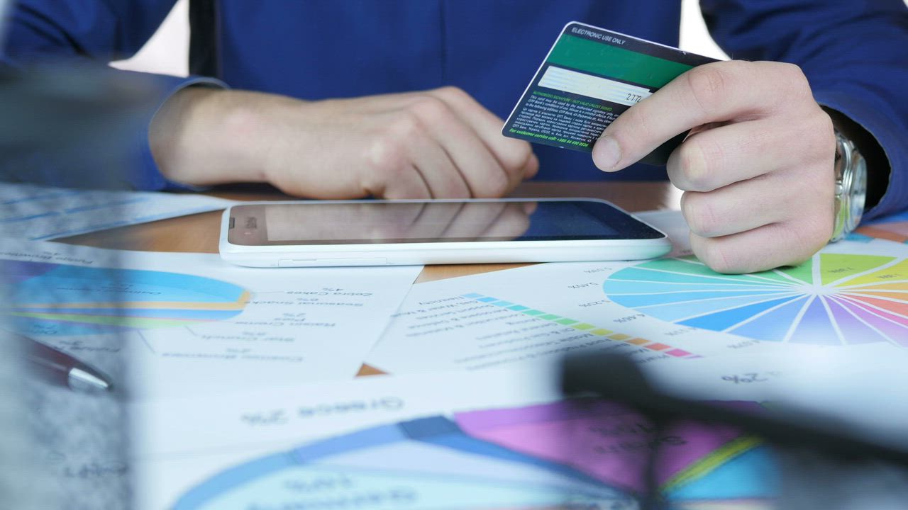 Man entering credit card details on his device - Free Stock Video