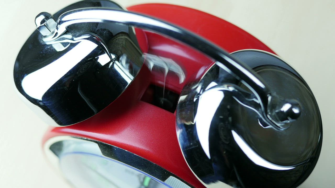 Hammer of an alarm clock hitting the bells - Free Stock Video