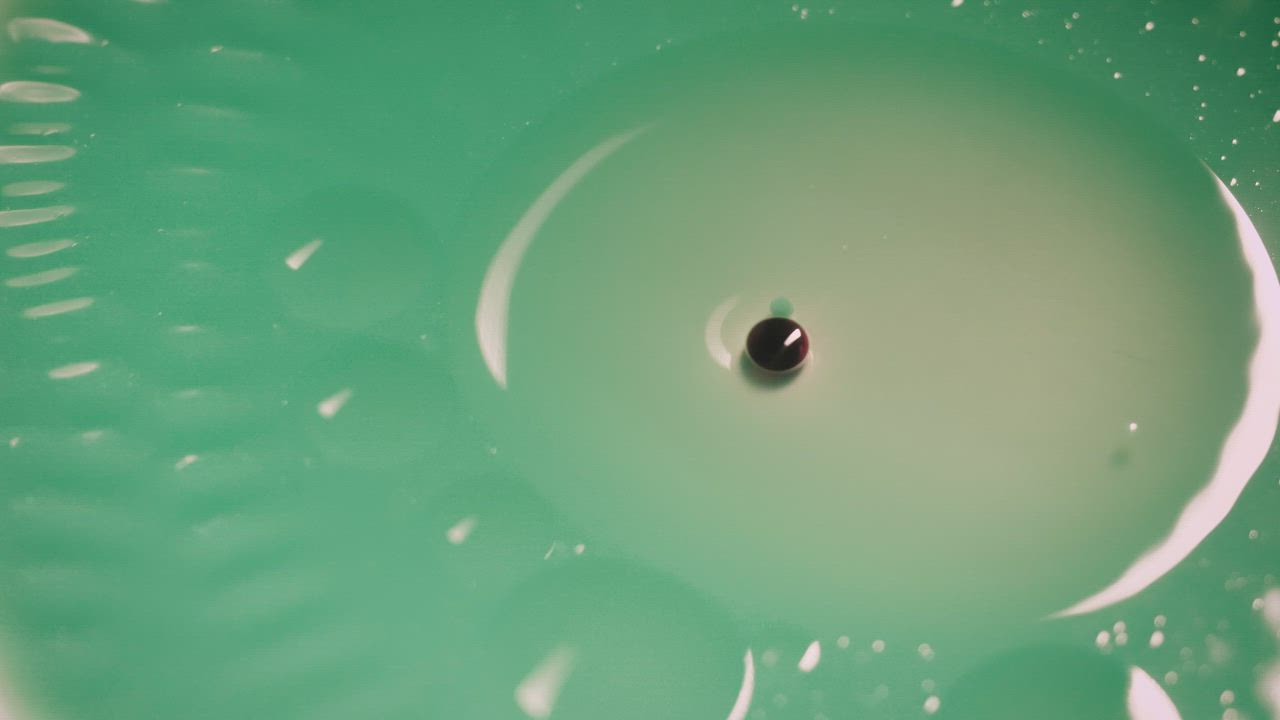 Green liquid with bubbles, close up - Free Stock Video