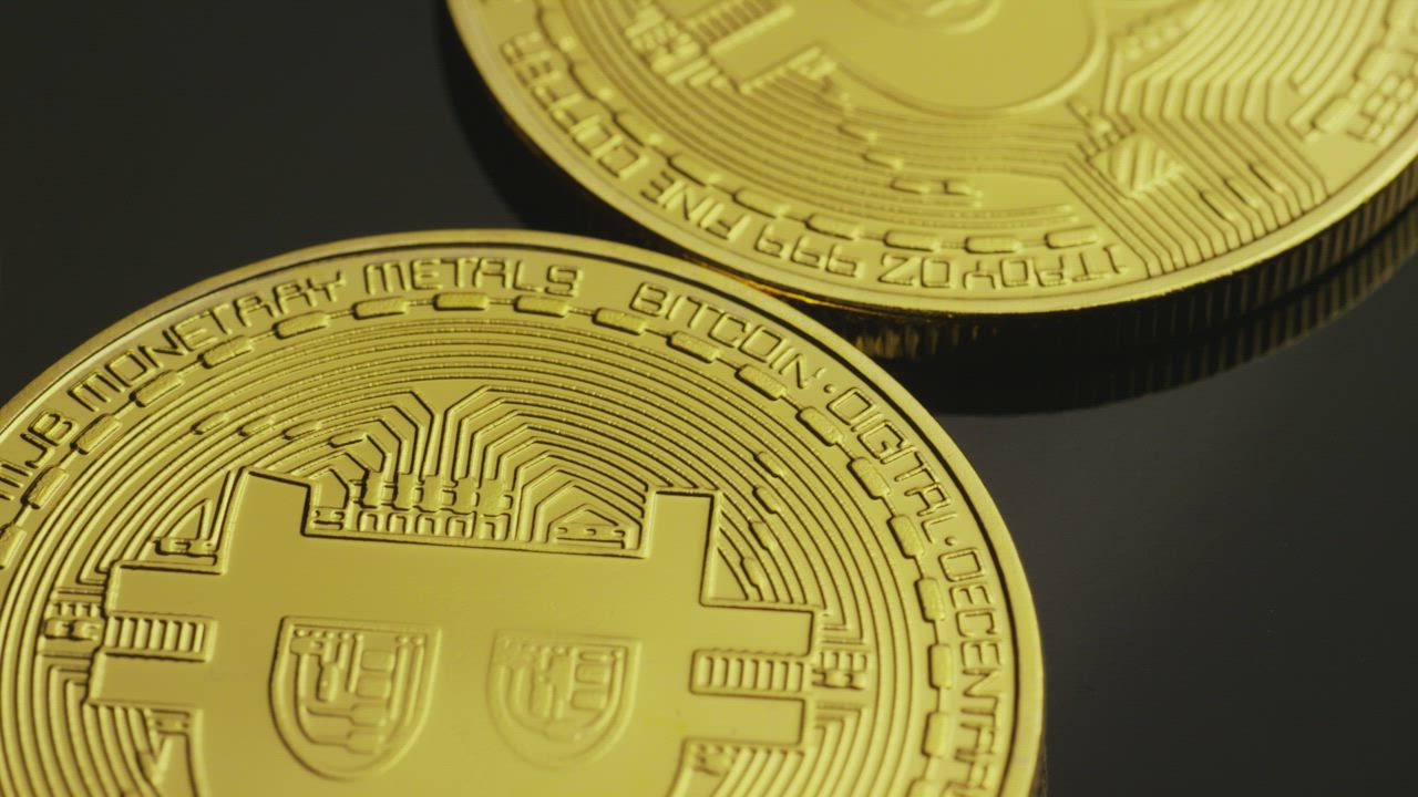 Golden bitcoin coins in a close-up shot - Free Stock Video