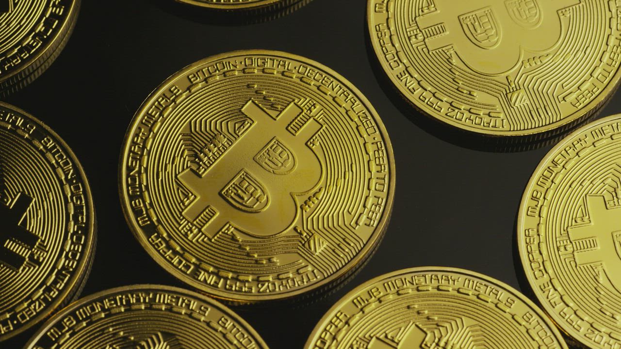 Real bitcoin coins on a black surface - Free Stock Video